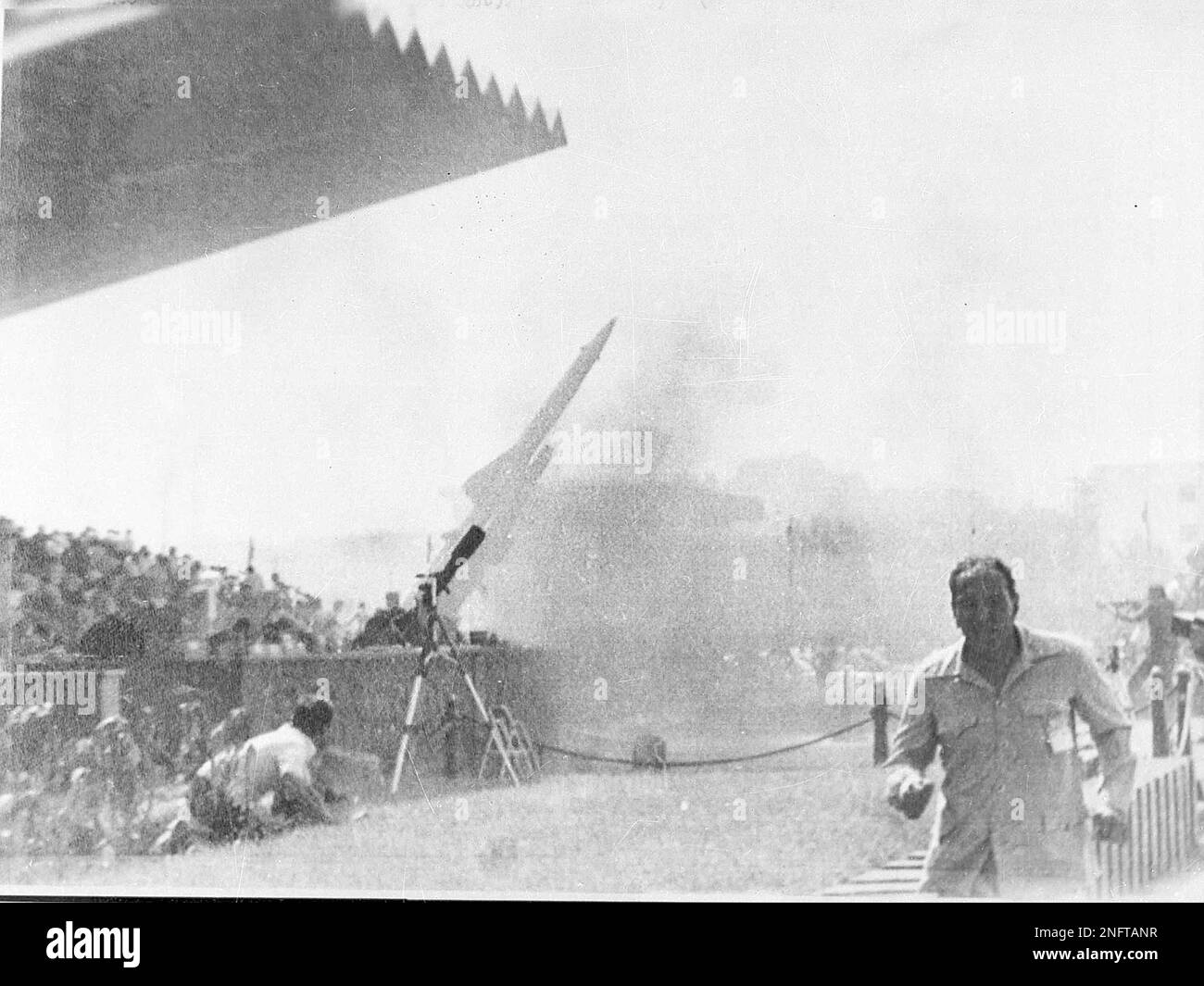 Smoke rises after a grenade exploded in front of the reviewing stand ...