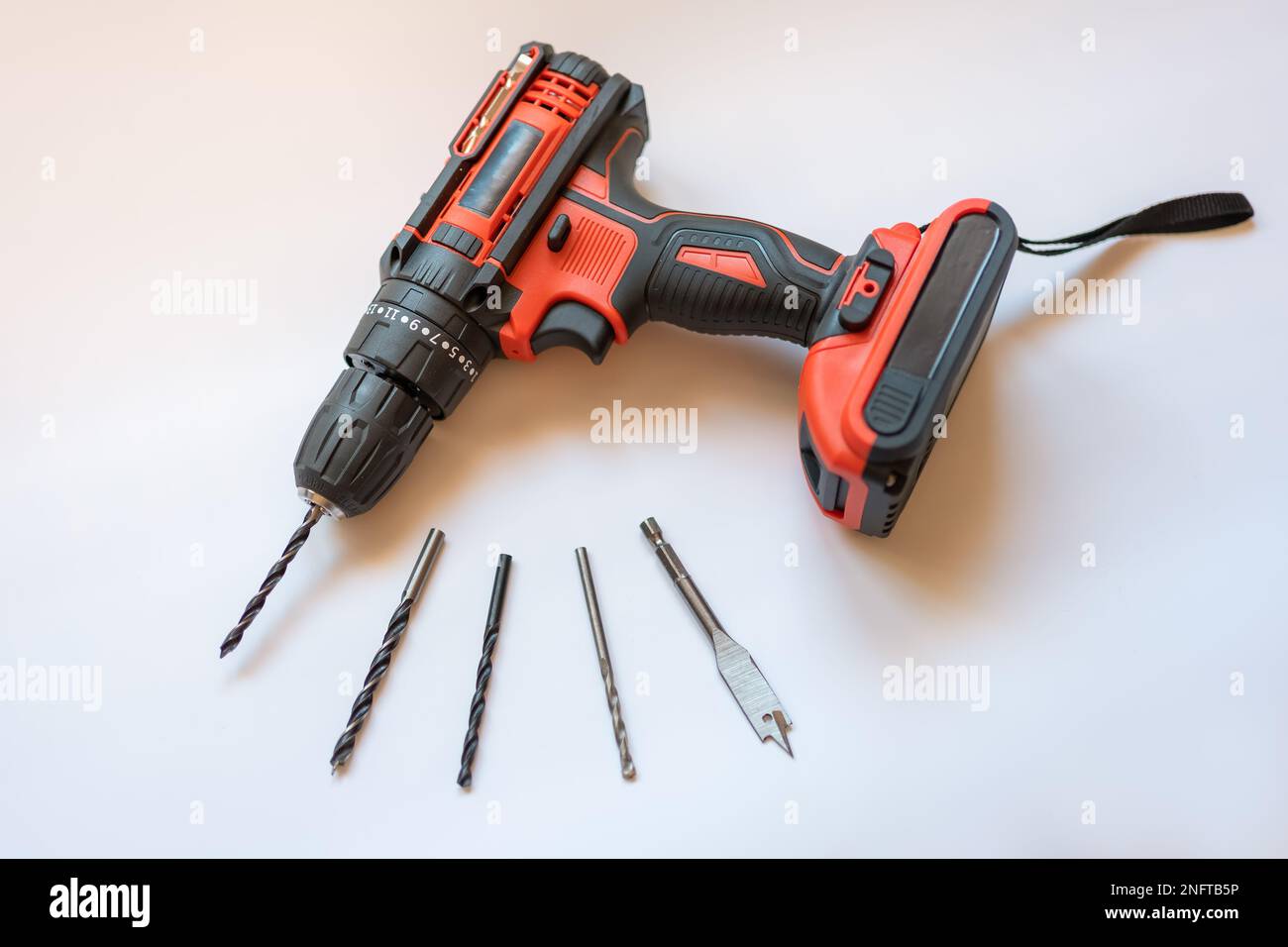 Set of bits of different types and electric drill without cables on ...