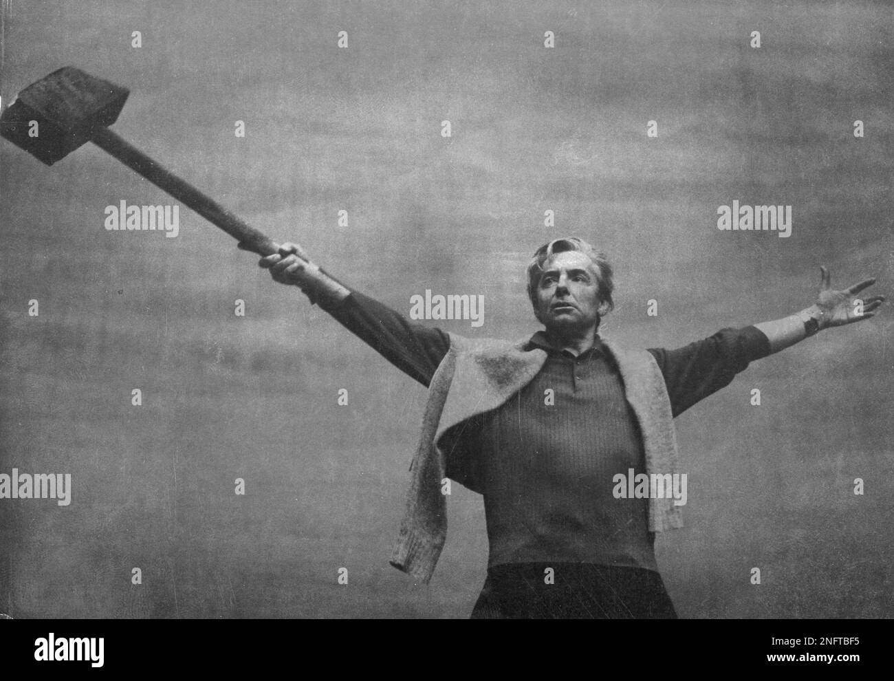 Austrian conductor Herbert von Karajan swings an oversized model of a ...