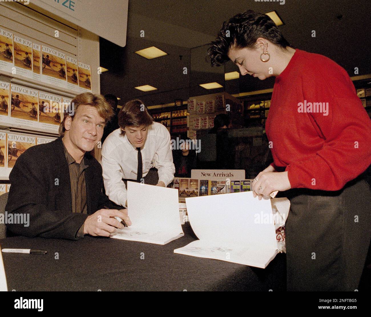 A fan gets a book autographed by actor Patrick Swayze at a book signing ...