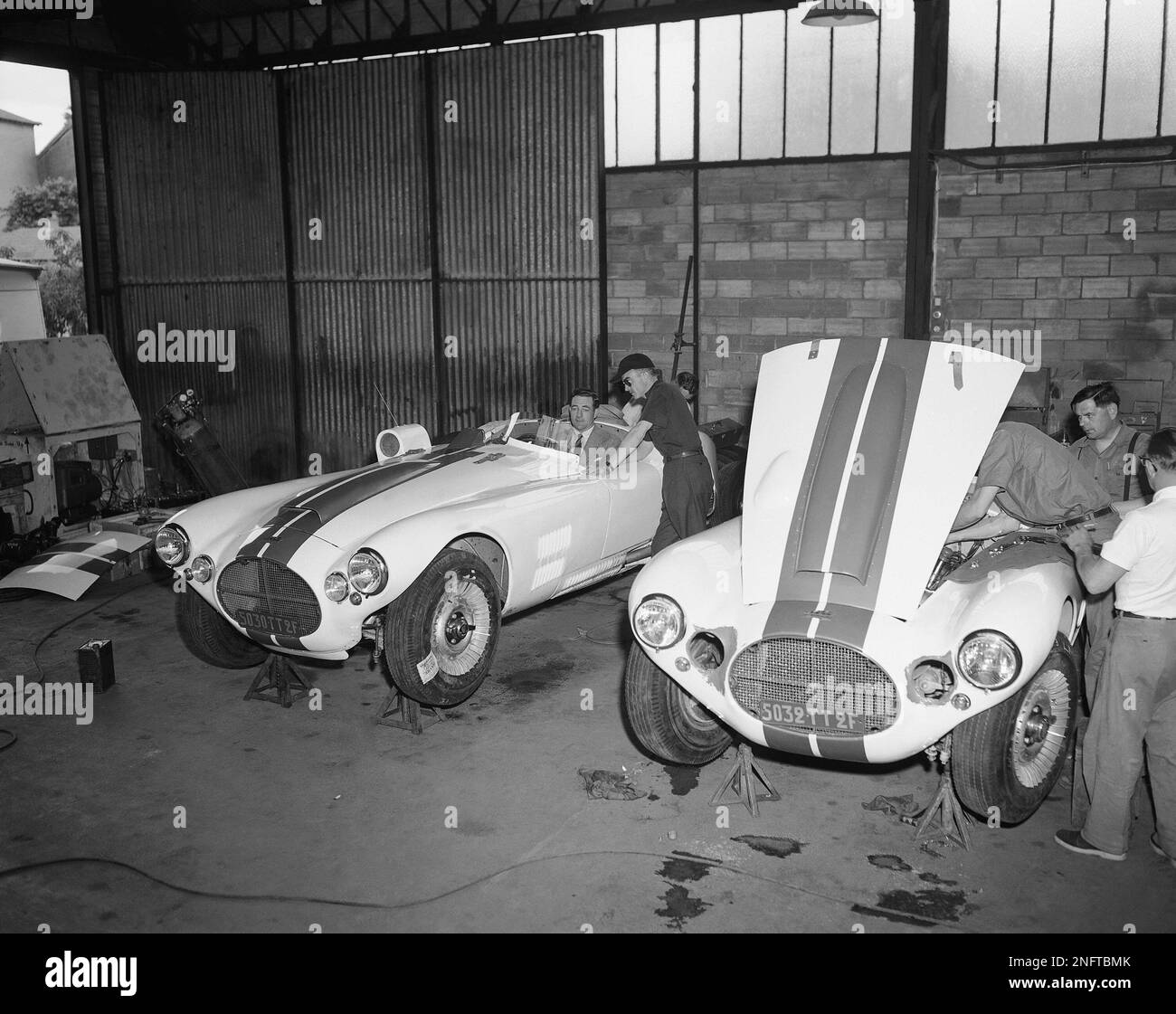 Briggs Cunningham (left) of Green Farms, Connecticut, sits at the ...