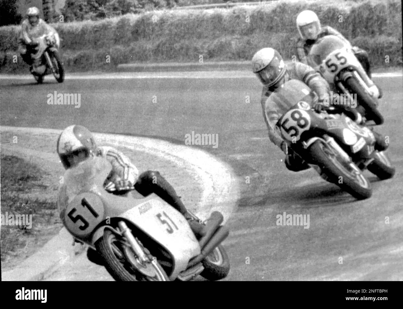 Italy's Giacomo Agostini, left No.51, leads New Zealand's Kim Newcombe ...