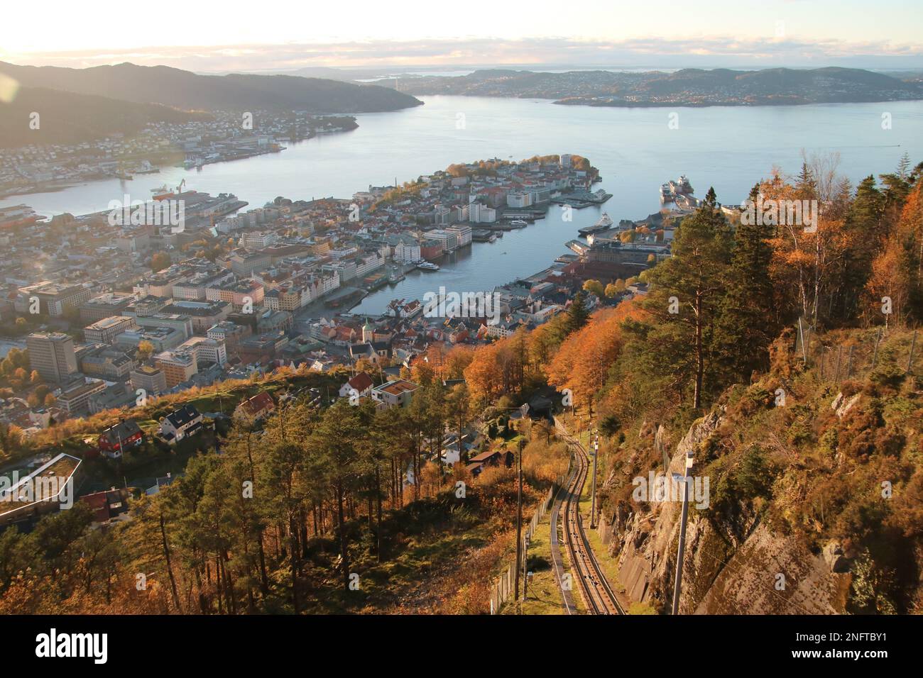 An aerial shot of the coastal city of Bergen and a railroad along ...