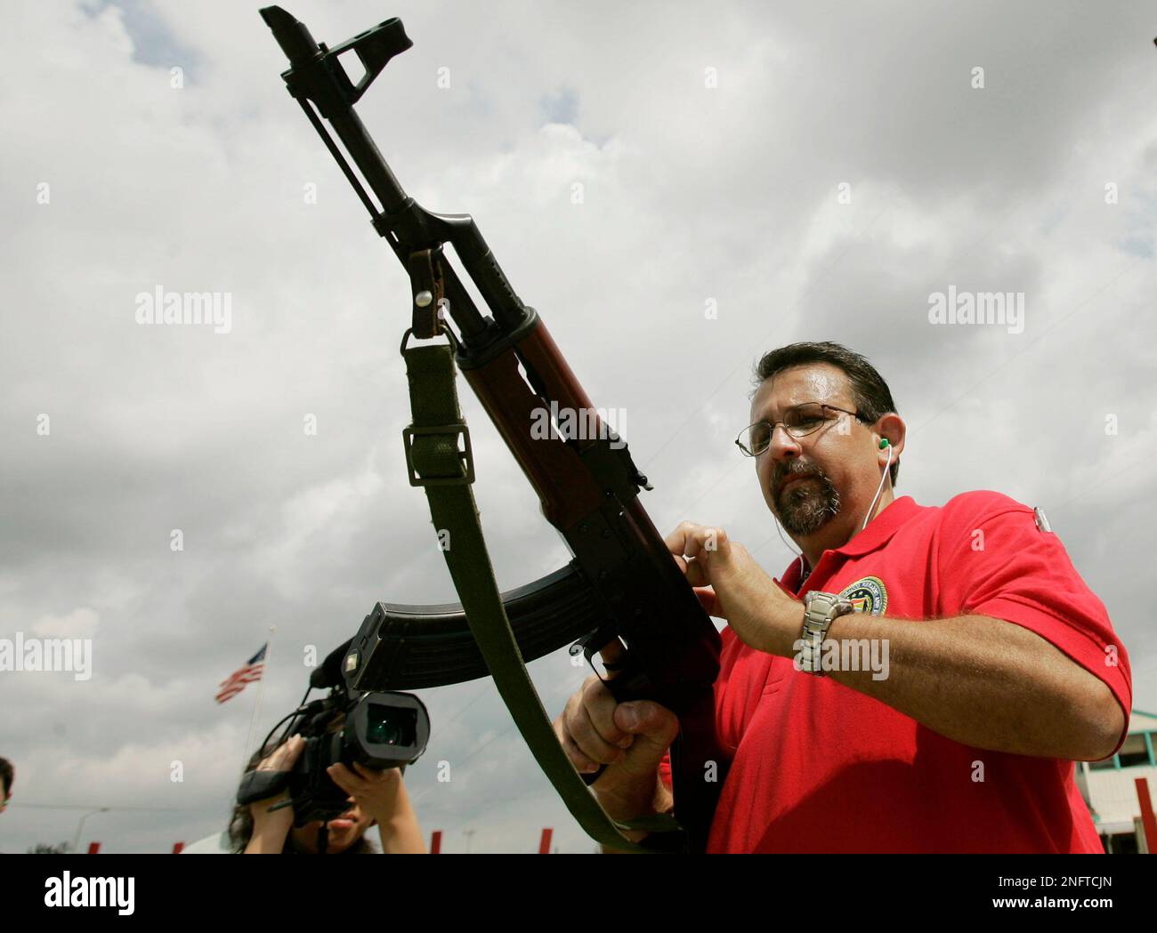 Supervisory ATF Special Agent Eduardo Halley prepares to fire an AK-47 ...