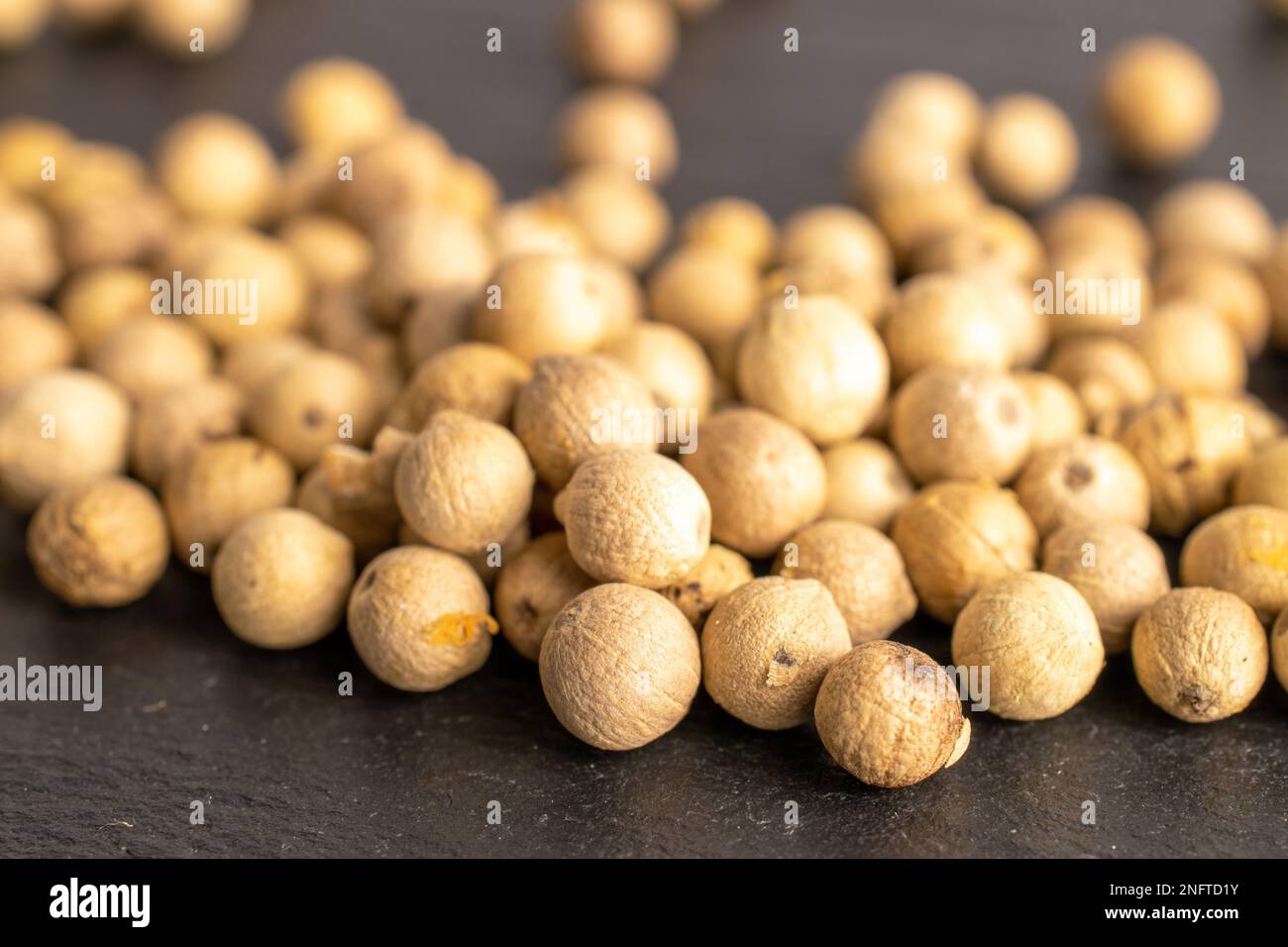 Fragrant vegetable coriander seeds on slate stone, macro Stock Photo ...