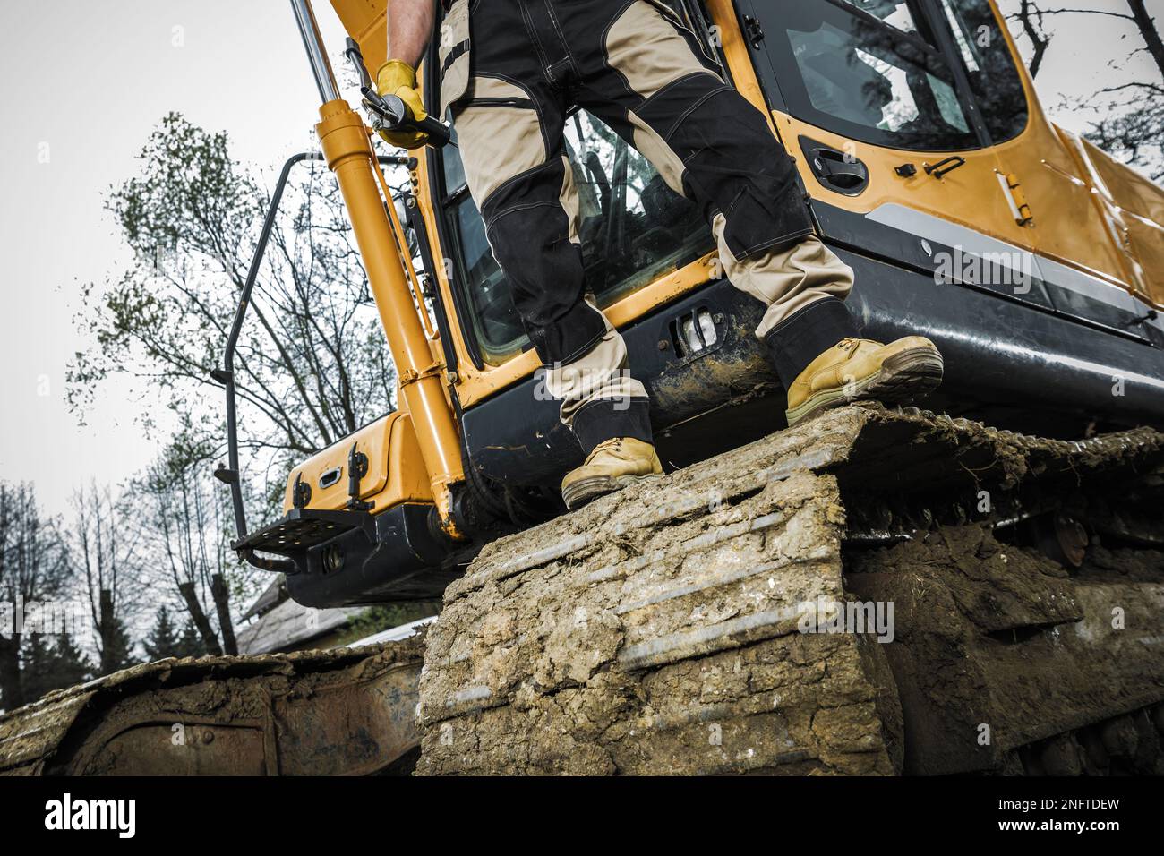 Industrial Excavator Operator Standing on the Crawler Track. Heavy Duty ...