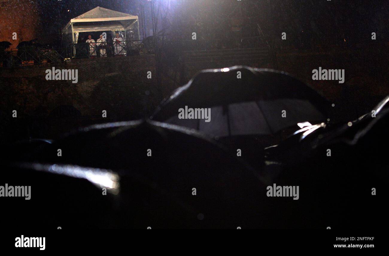 Pope Benedict XVI, white figure at center under shelter, celebrates the ...