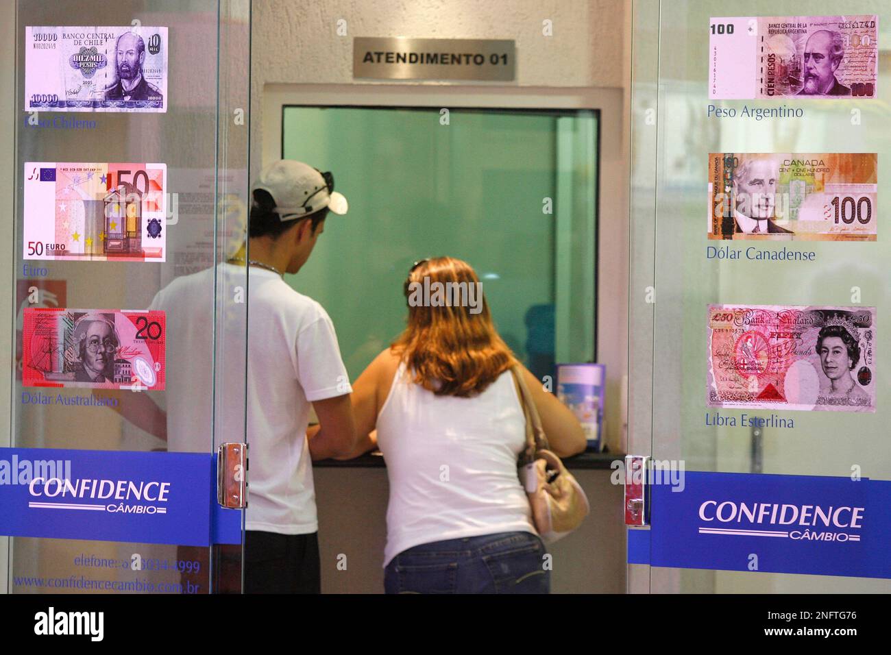 People exchange money at currency exchange office in Brasilia, Feb. 28 ...