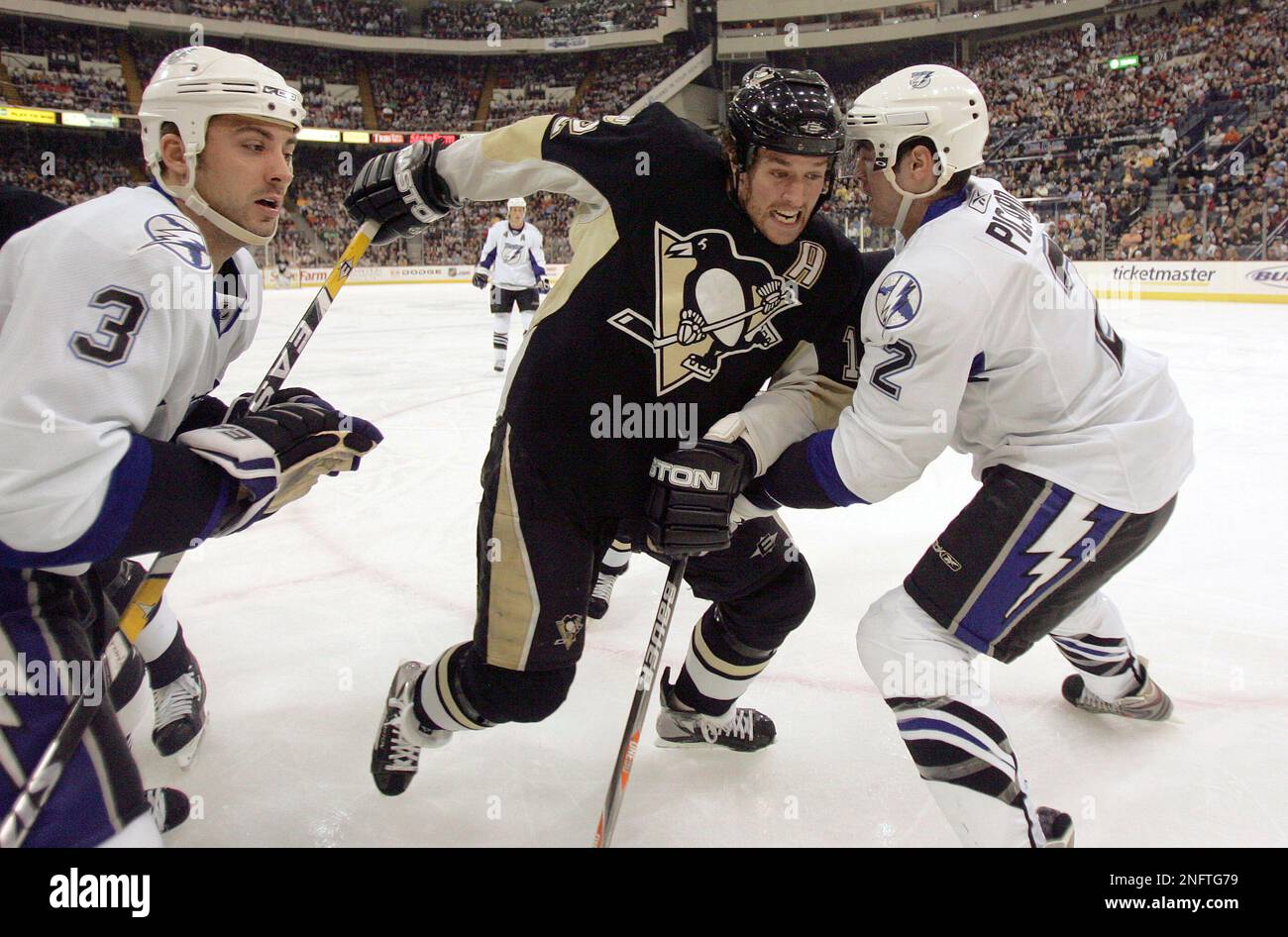 Pittsburgh Penguins' Ryan Malone, center, is sandwiched by Tampa Bay ...