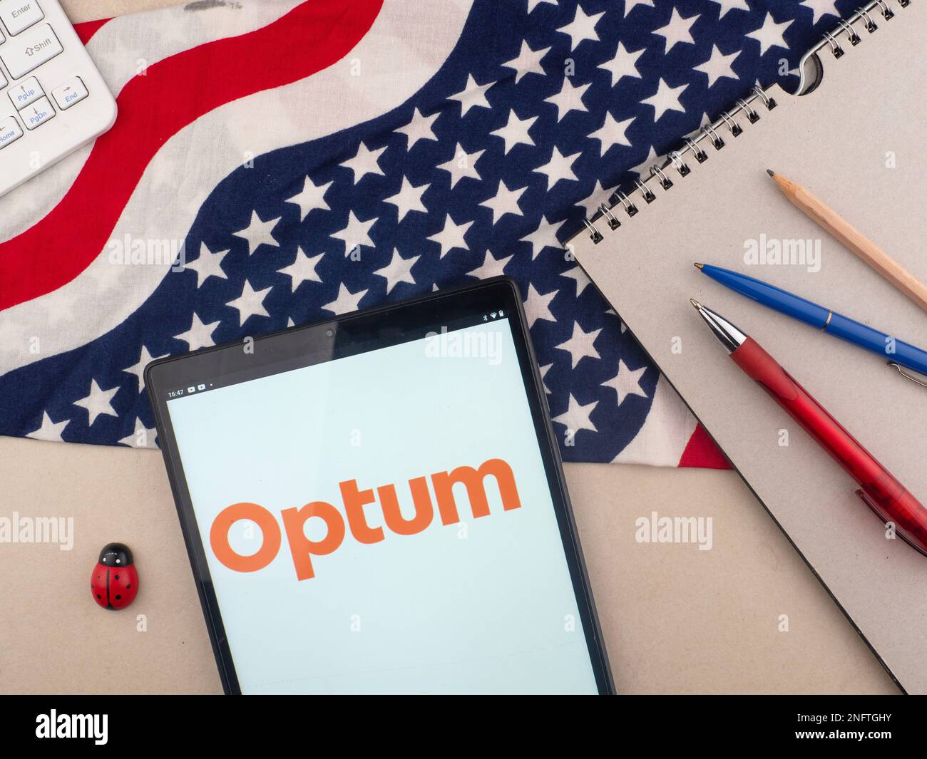 In this photo illustration, Optum, Inc. logo seen displayed on a tablet ...