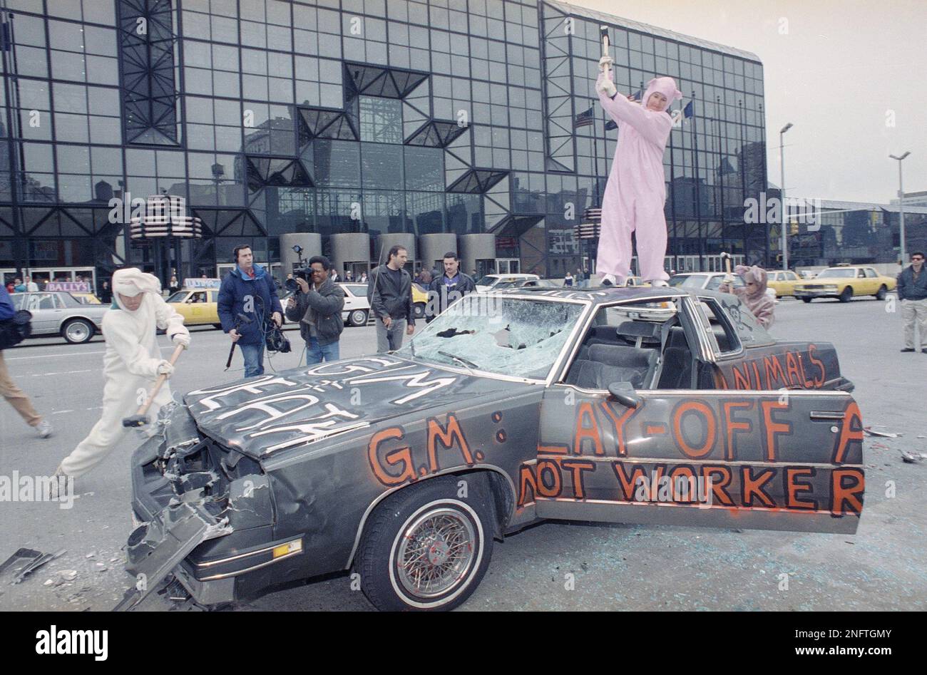 Peter Wood, left, Ann MacMahon, atop car, and Nancy Draper, rear, smash ...
