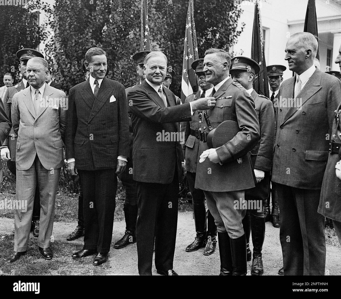 President Hubert Hoover pins a gold medal on Major General Anton ...