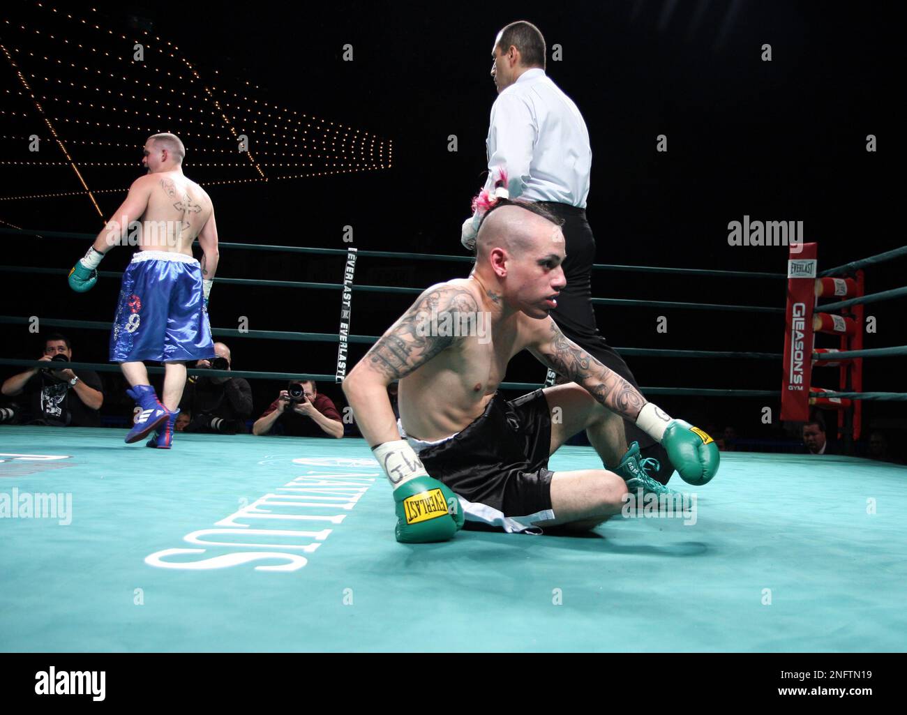 Jose Espinal walks to a neutral corner after knocking down Joe Rosa ...