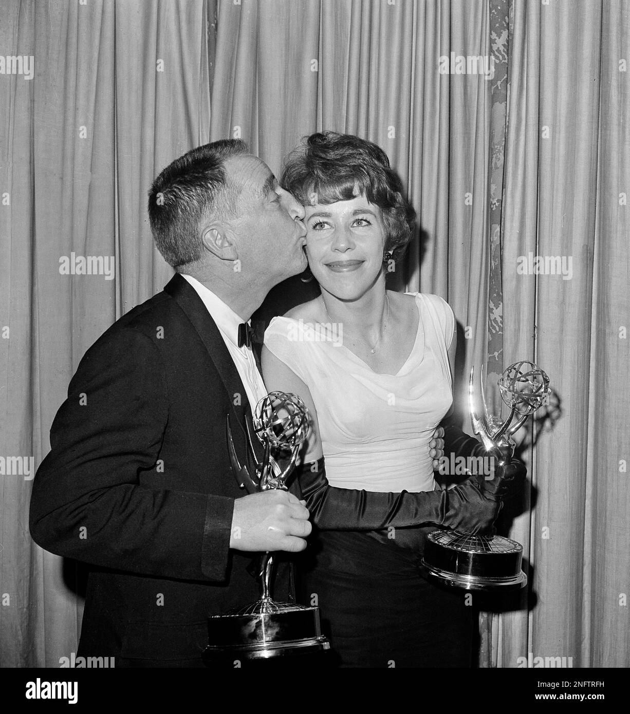 Comedian Garry Moore kisses Carol Burnett at the Hotel Astor in New ...