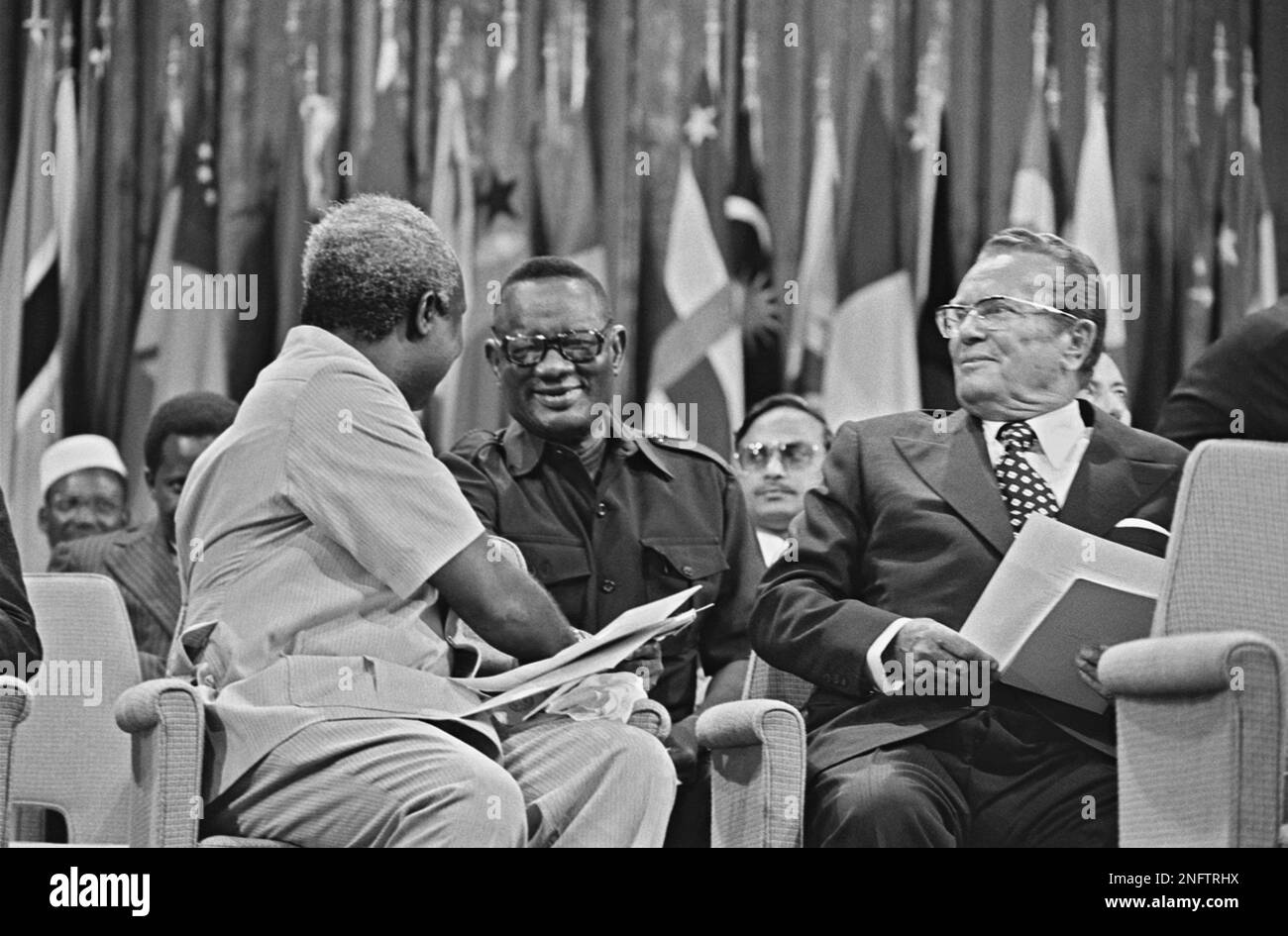 Yugoslavia President Josip Broz Tito turns to join the smiling ...