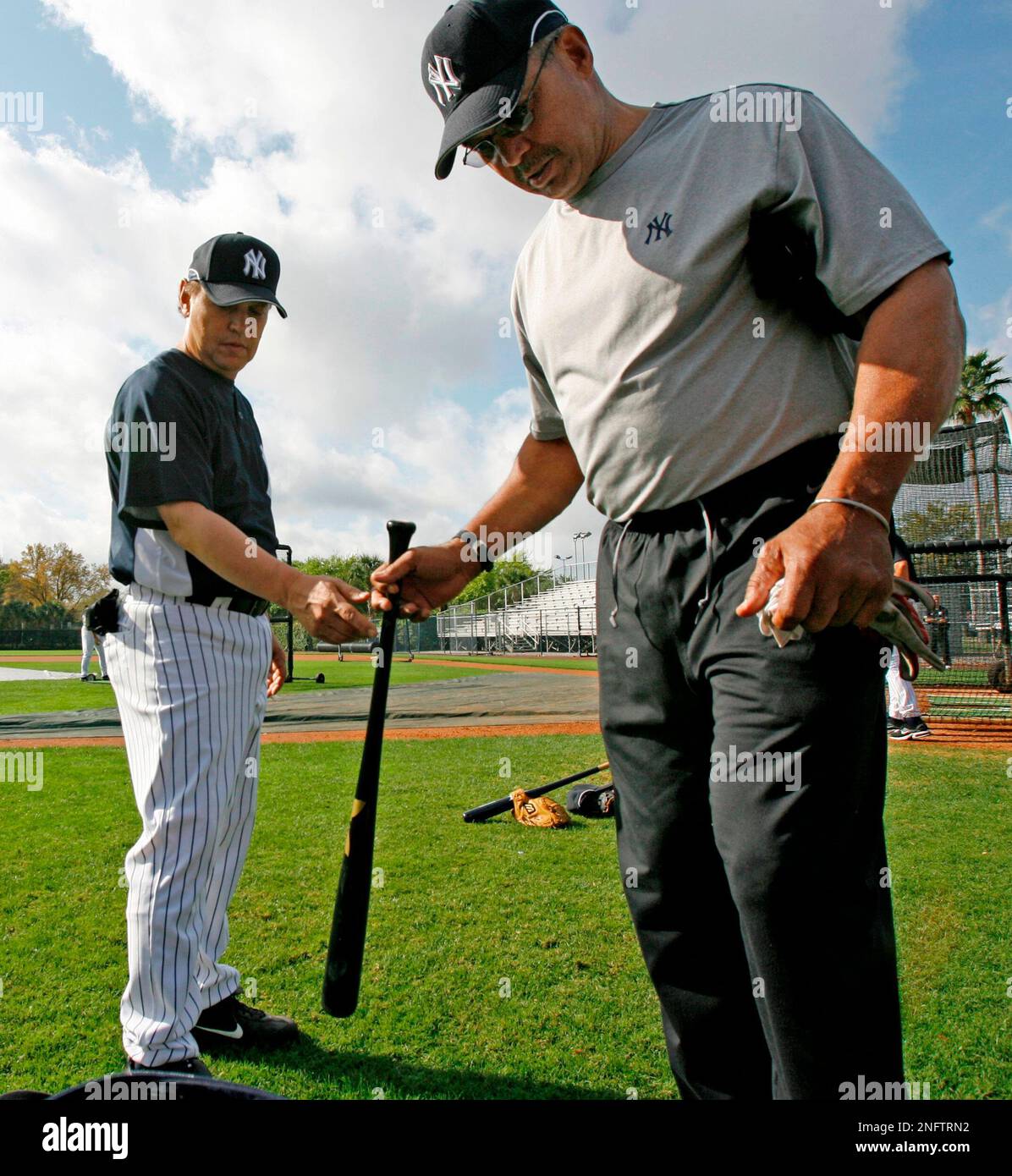 New York Yankees special adviser Reggie Jackson hands a bat to actor ...