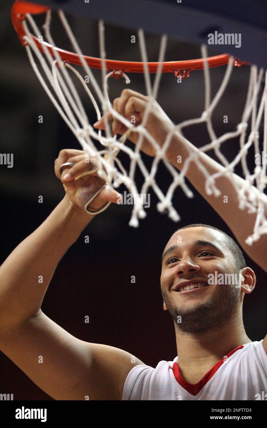 Western Kentucky's D.J. Magley (35) cuts down a piece of the net after ...