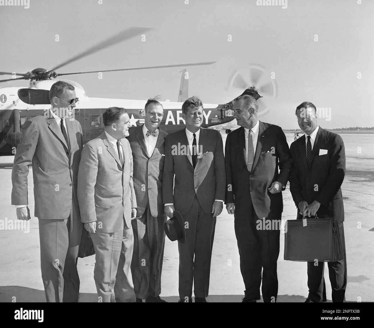 President John Kennedy poses with menber of his party before air ...