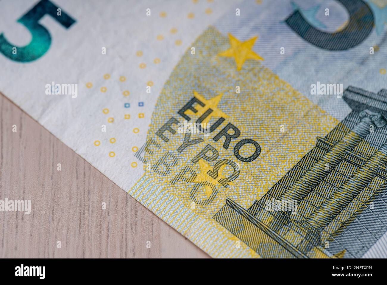 5 euro banknote close up, wooden table background for business finance ...