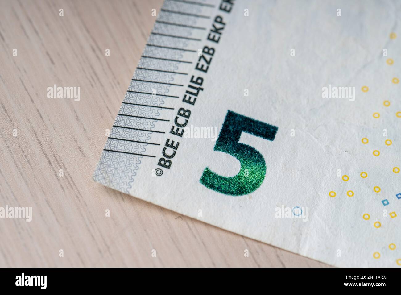 5 euro banknote close up, wooden table background for business finance ...