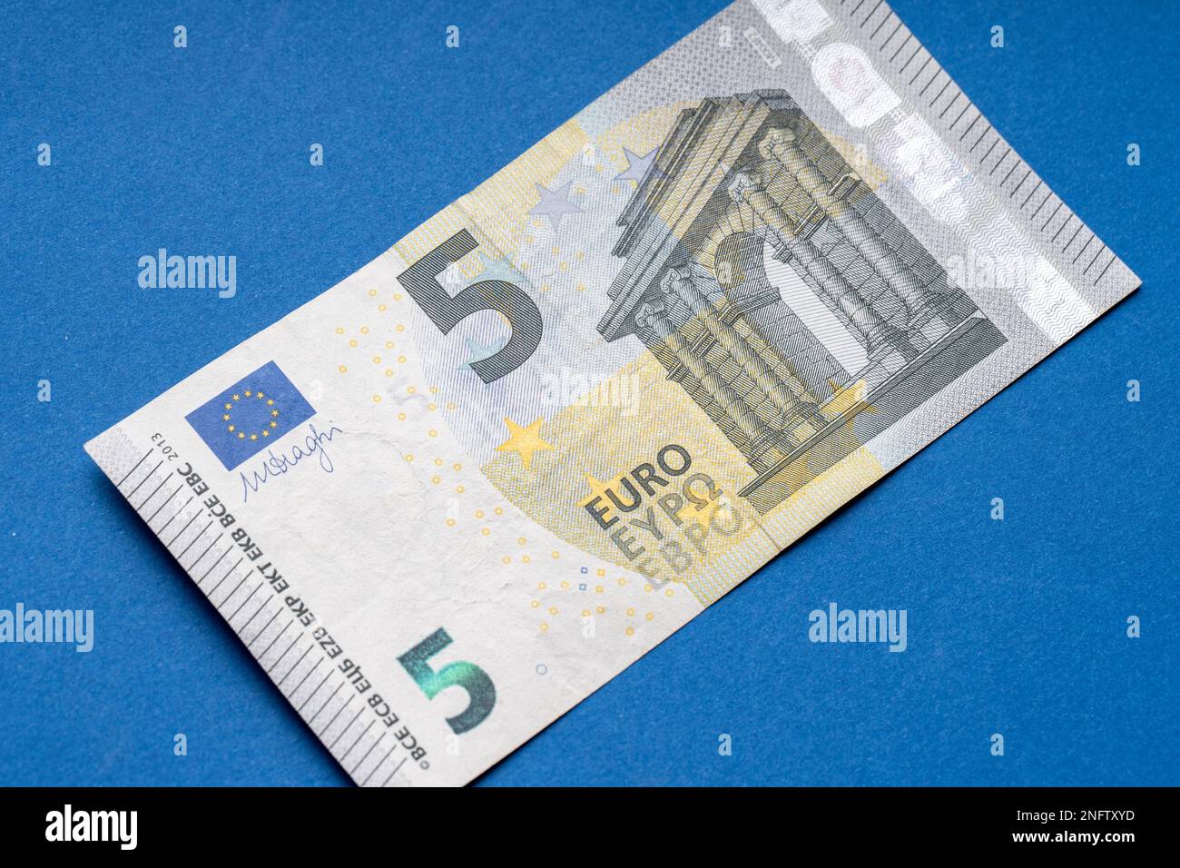 5 euro banknote close up, blue background for business finance topics ...