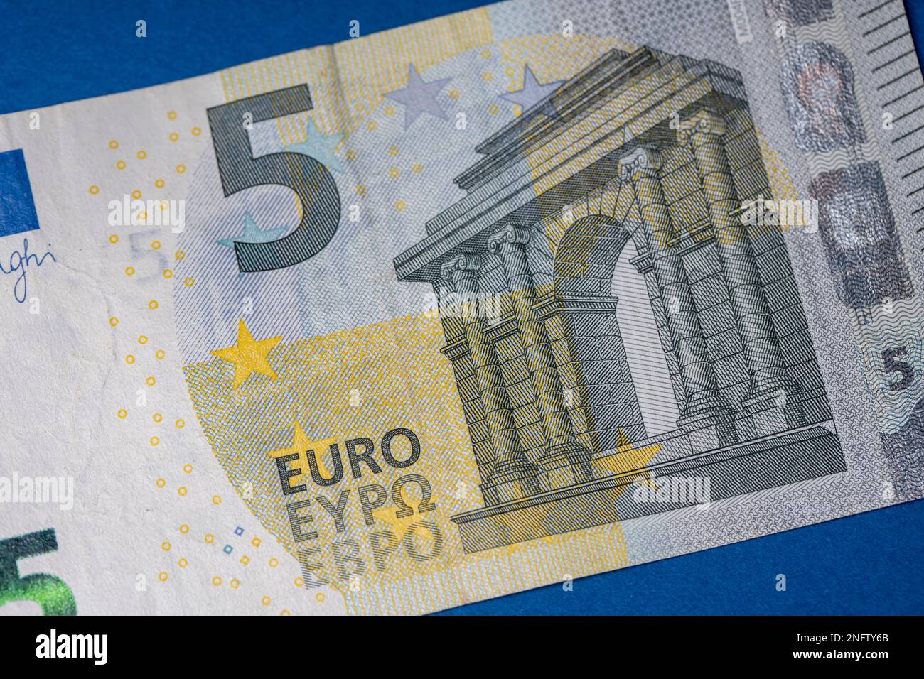 5 euro banknote close up, blue background for business finance topics ...
