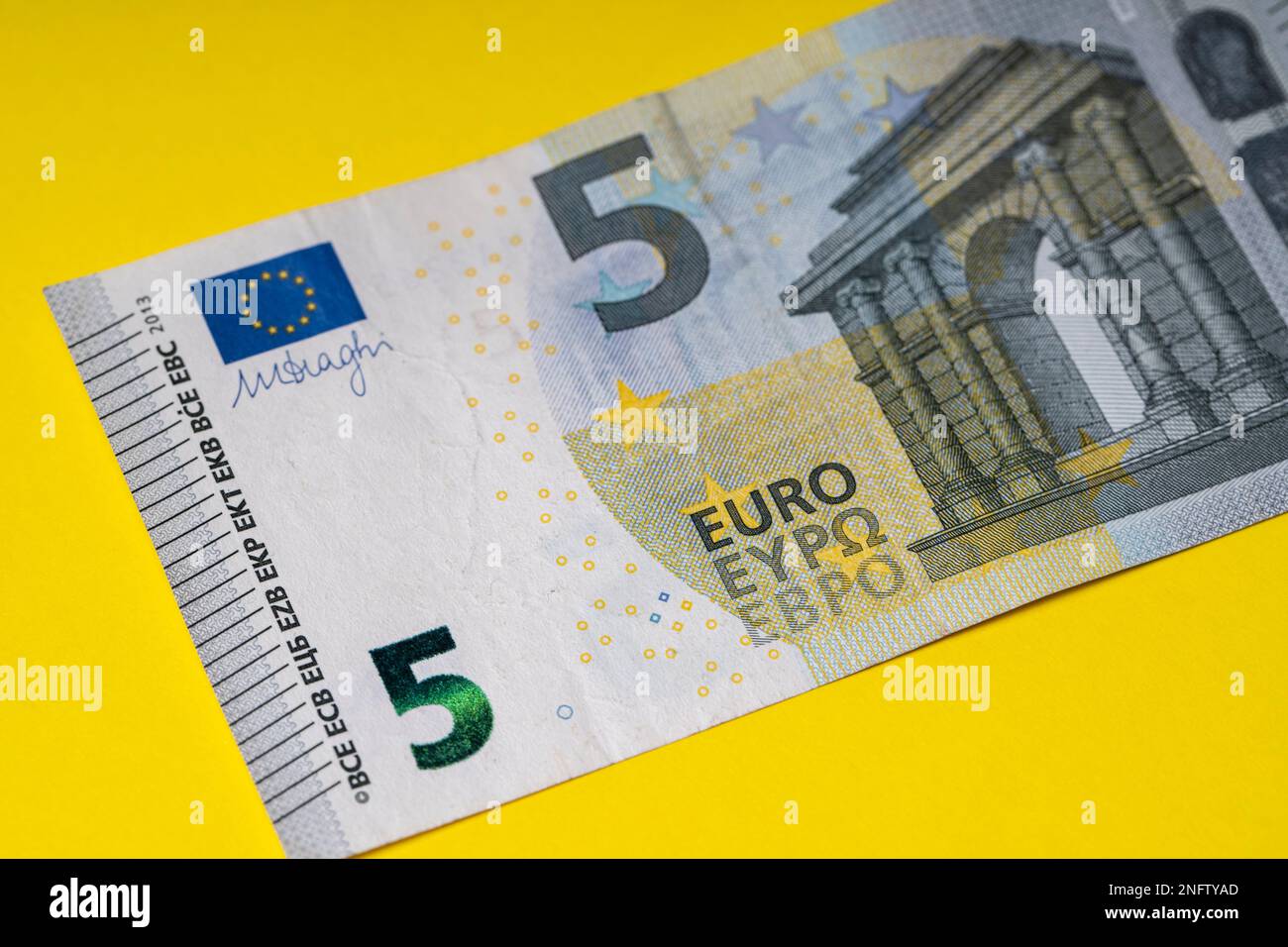 5 euro banknote close up, yellow background for business finance topics ...