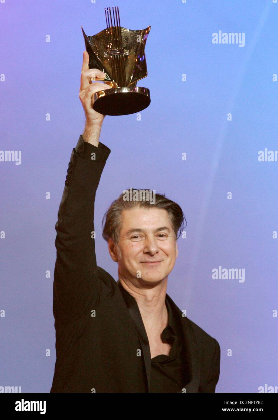 French singer Etienne Daho raises the Pop Rock album of the year award ...
