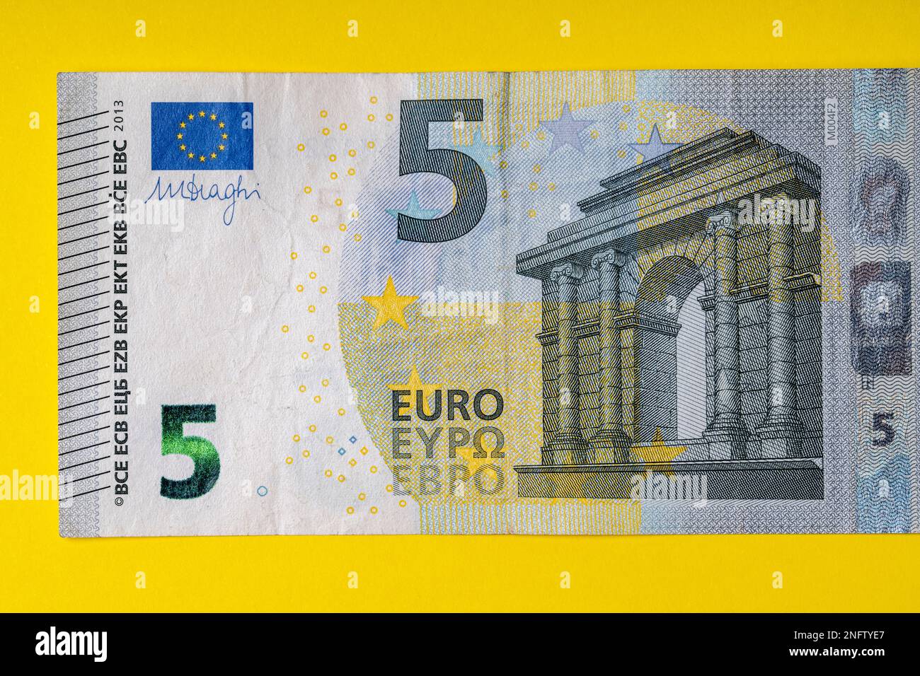 5 euro banknote close up, yellow background for business finance topics ...