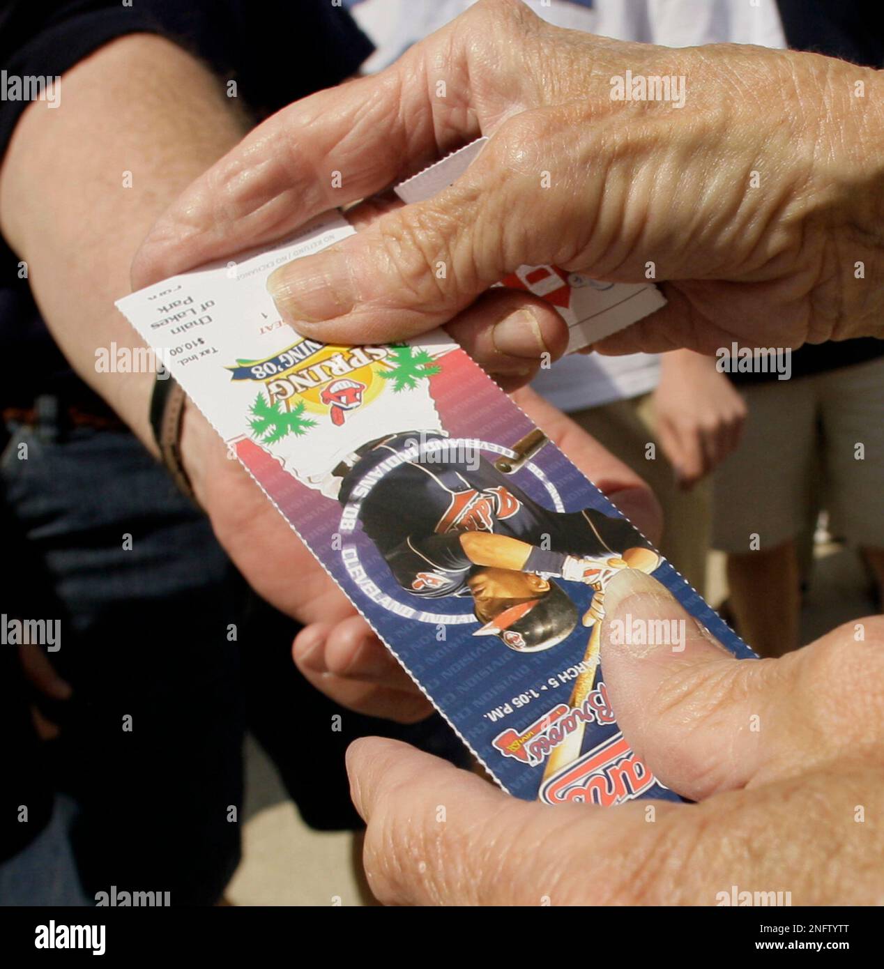 A ticket taker accepts a ticket from a fan at a Grapefruit League ...
