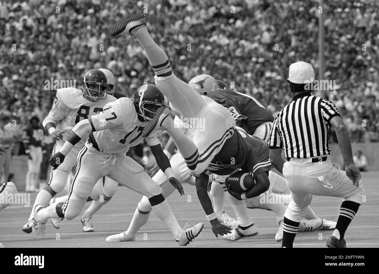 Johnny Lam Jones of the University of Texas, is upended on a kickoff ...