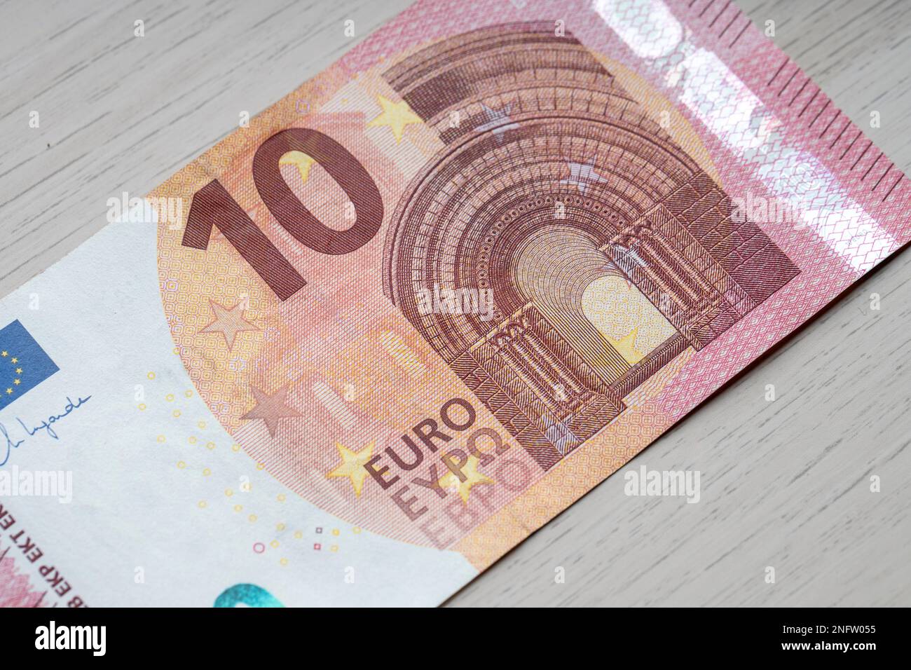 10 euro banknote close up, wooden table background for business finance ...