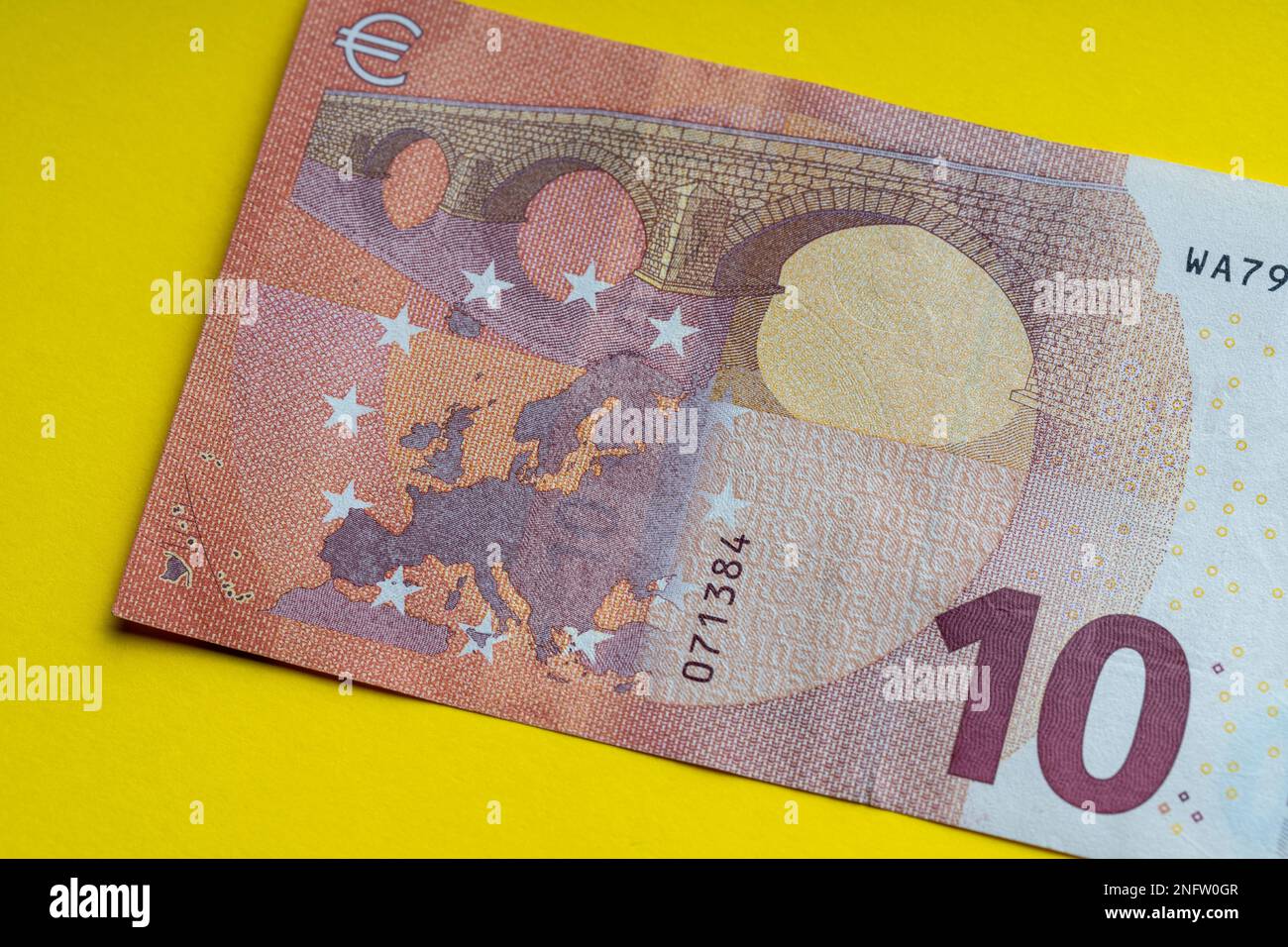 10 euro banknote close up, yellow background for business finance ...