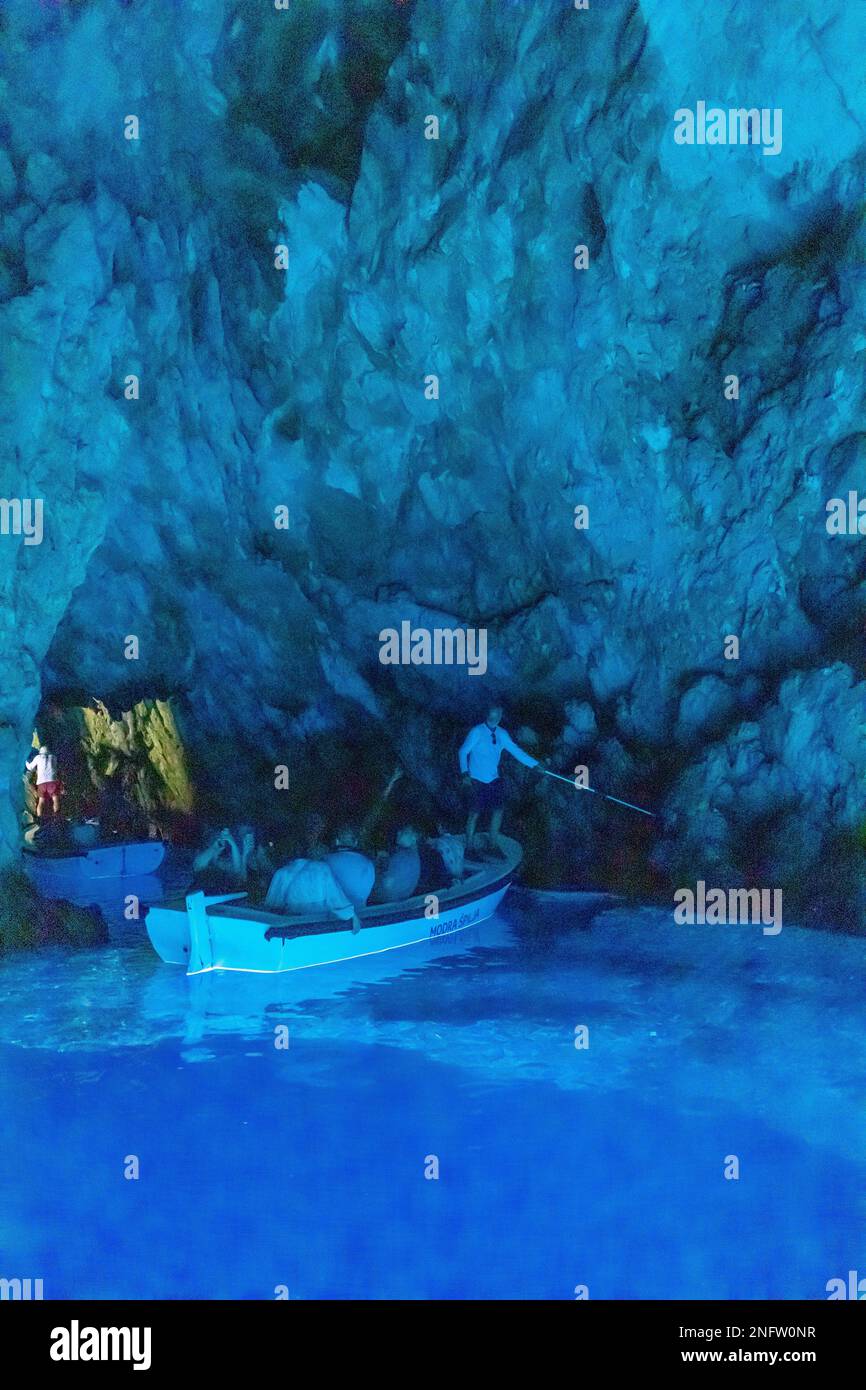 BISEVO ISLAND, CROATIA, EUROPE - Tourists in boat explore Blue Cave ...