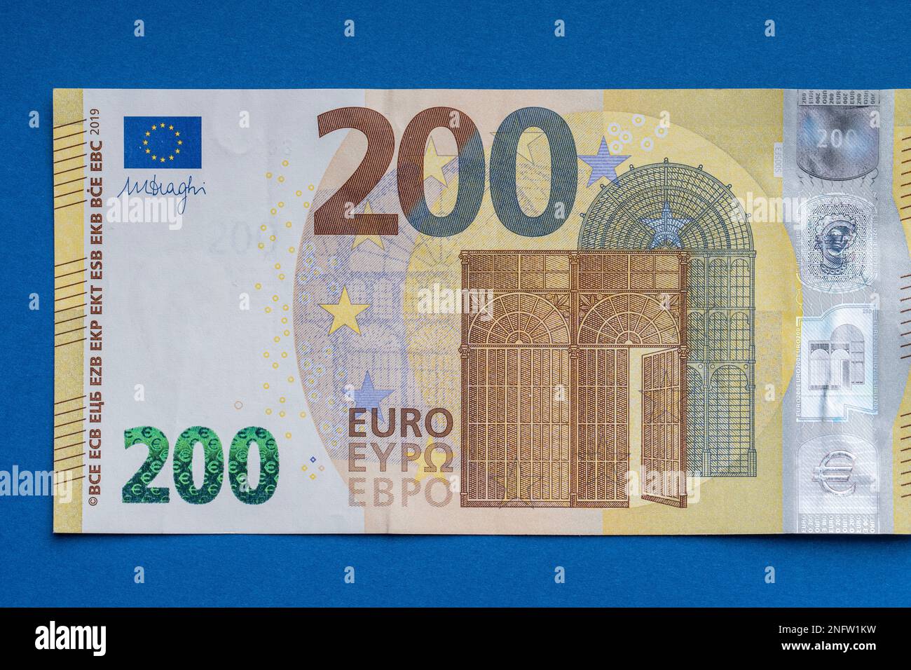 200 euro banknote close up, blue background for business finance topics ...