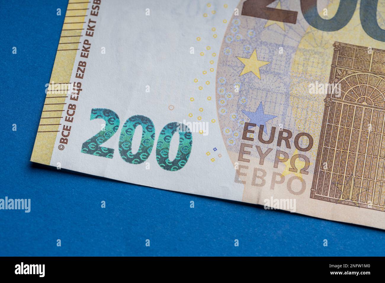 200 euro banknote close up, blue background for business finance topics ...