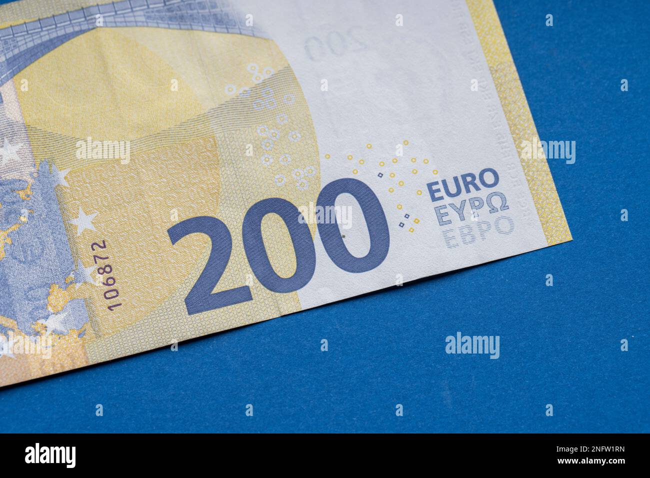 200 euro banknote close up, blue background for business finance topics ...