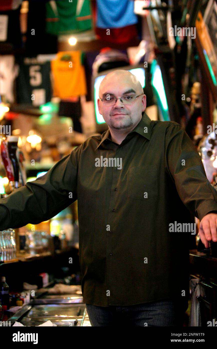 Owner Shaun Clancy poses for a picture behind the bar at Foley's Pub ...