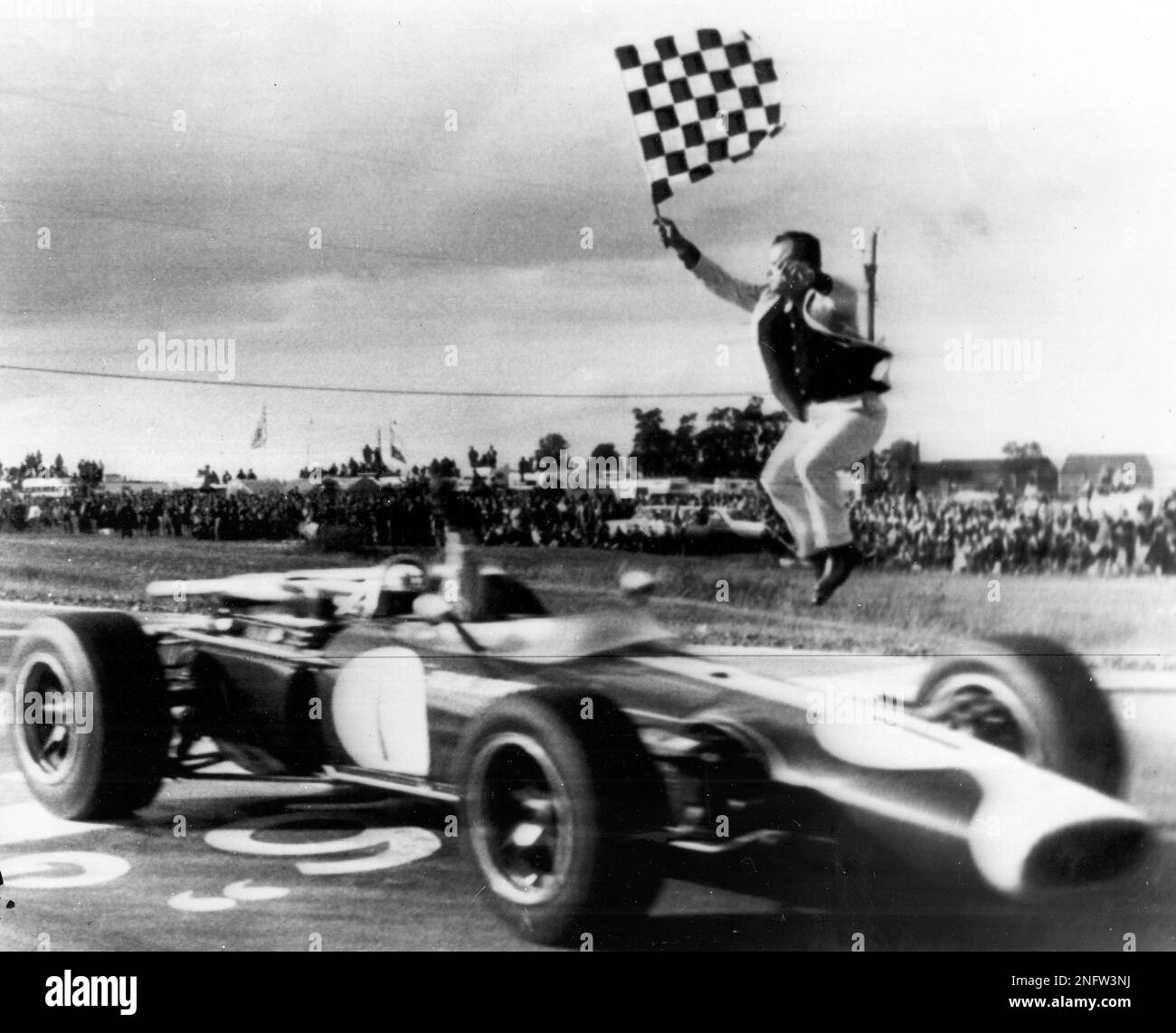 British auto racer Jim Clark crosses the finish line to win the eight U ...
