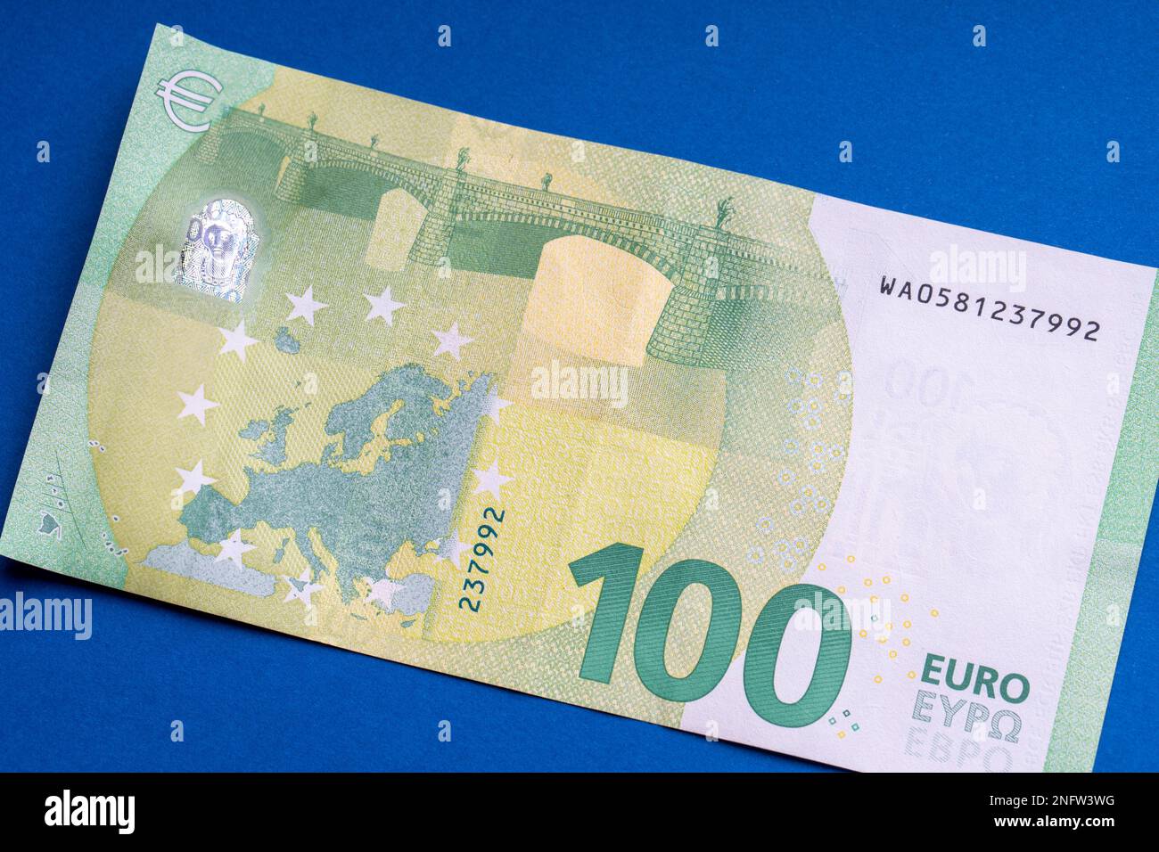 100 euro banknote close up, blue background for business finance topics ...