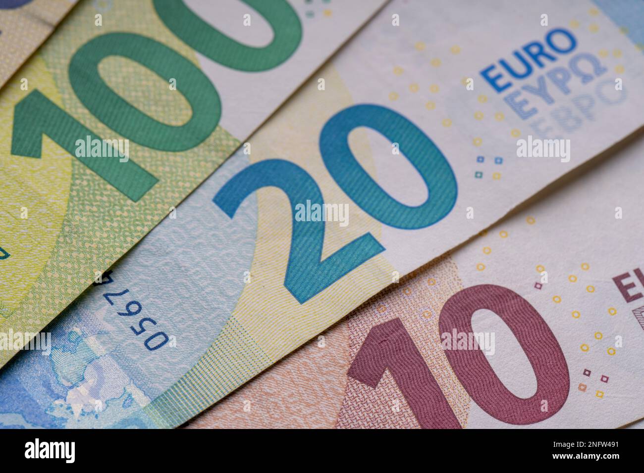 Different euro banknotes in a row close up, blue background for ...