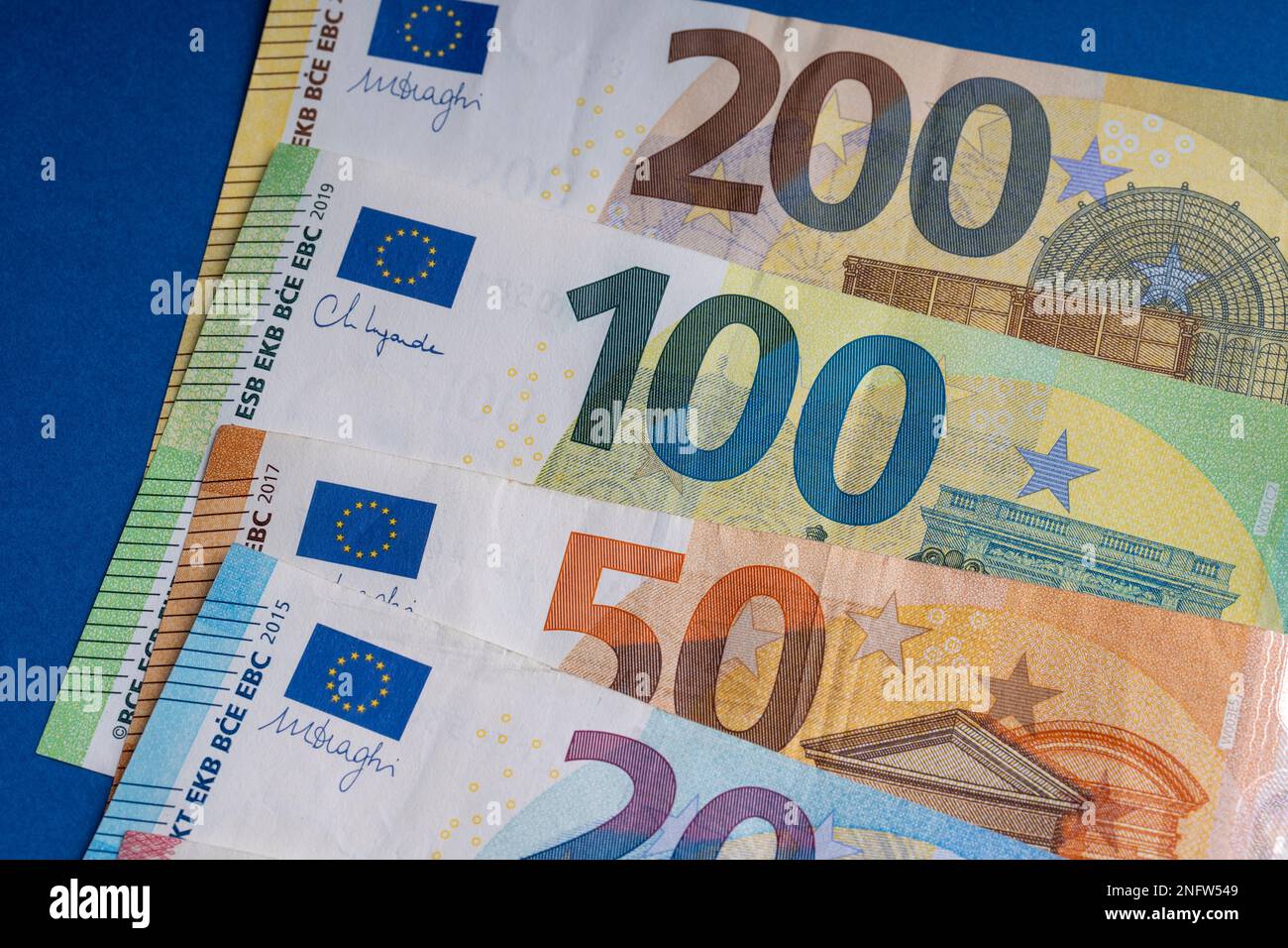 Different euro banknotes in a row close up, blue background for ...