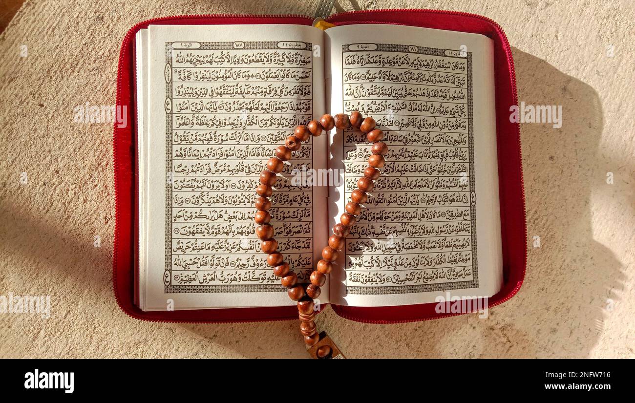 The Koran and prayer beads, symbols of Islam on a white surface Stock ...