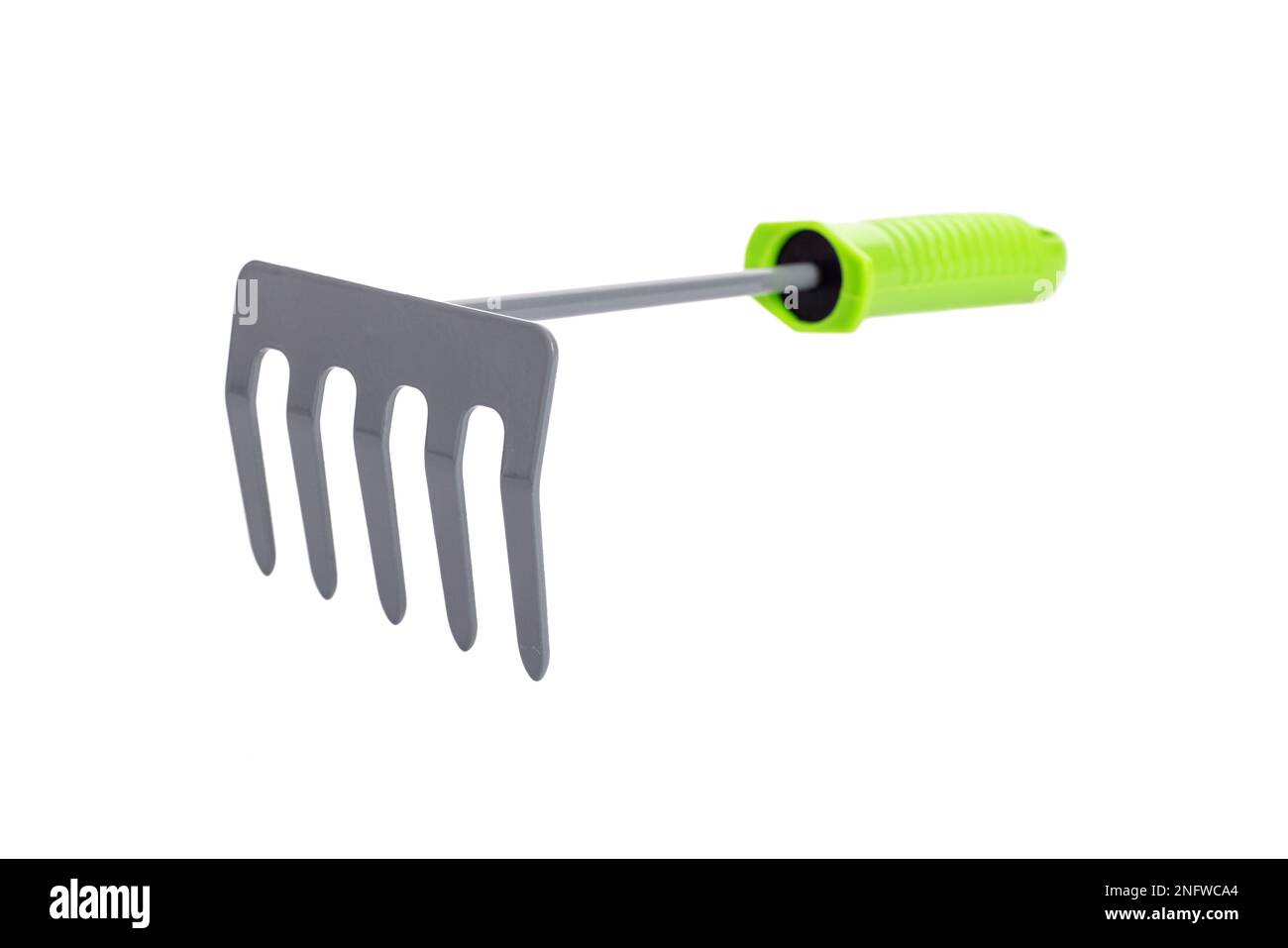 Small garden rake with green plastic handle isolated on a white ...