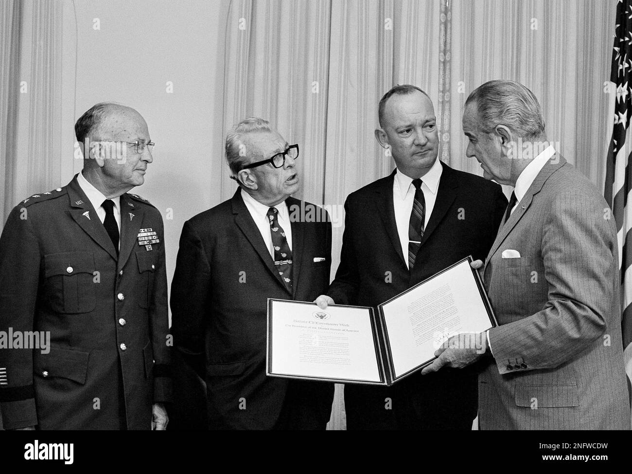 President Lyndon Johnson, at right, presents a copy of the Proclamation ...