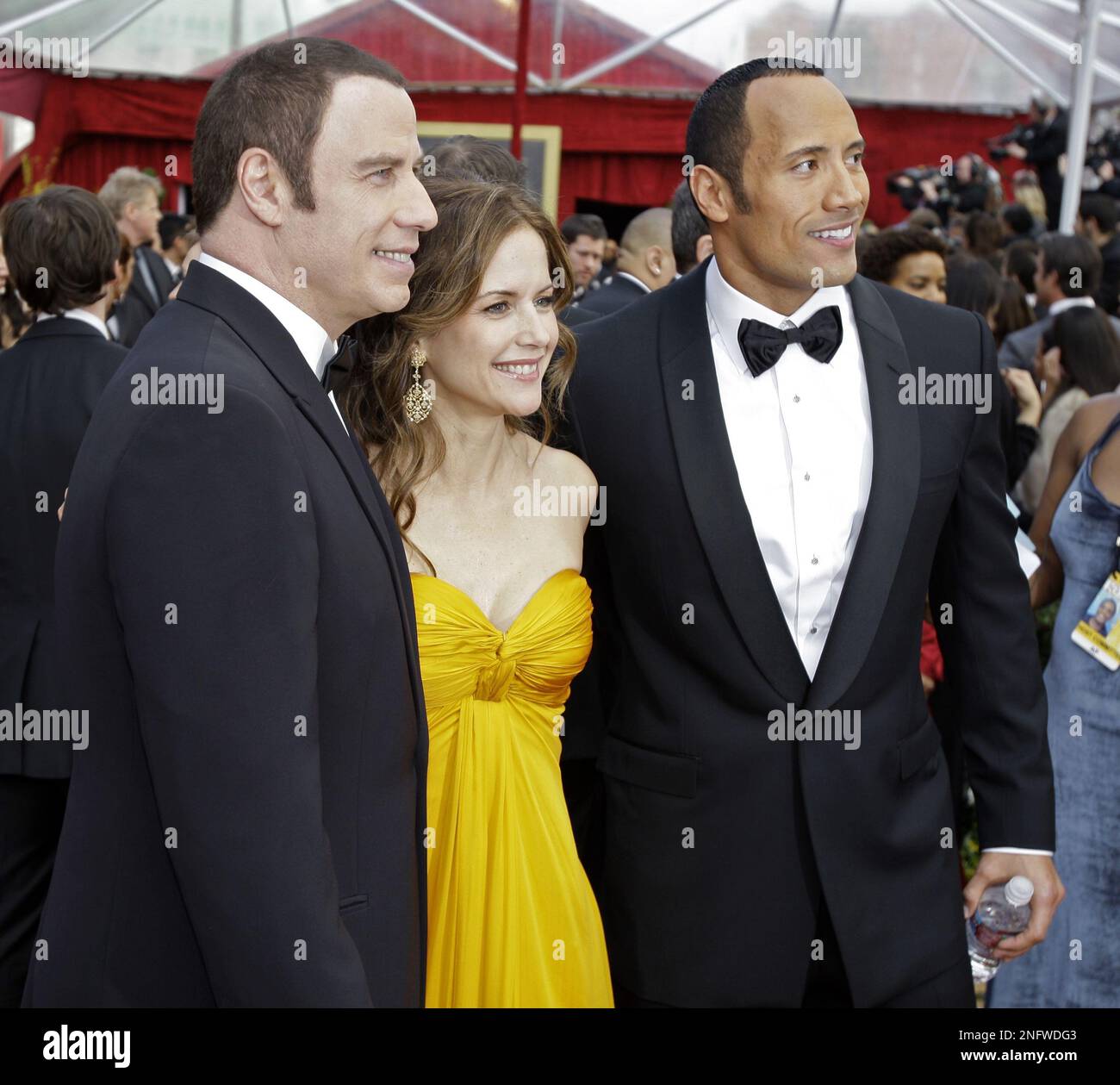 John Travolta, left, Kelly Preston and Dwayne Johnson arrive at the ...