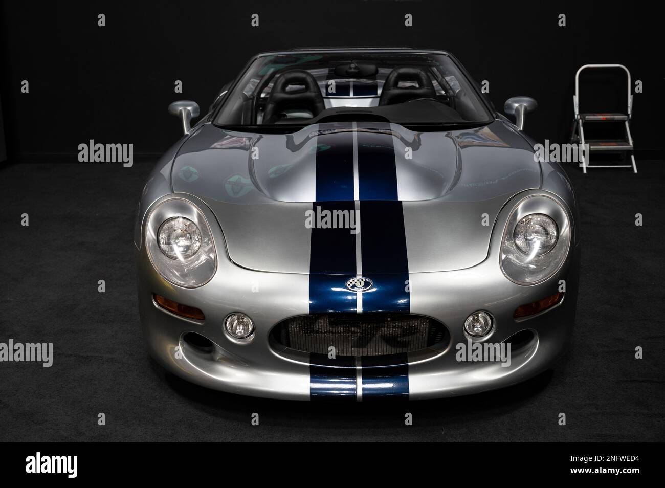 A detail of the unique silver Shelby Series 1 racing car with two blue ...