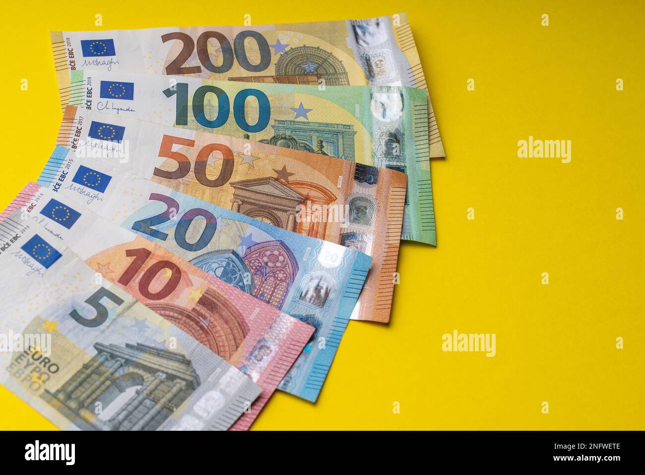 On the table is a pile of banknotes in denominations of five, ten ...