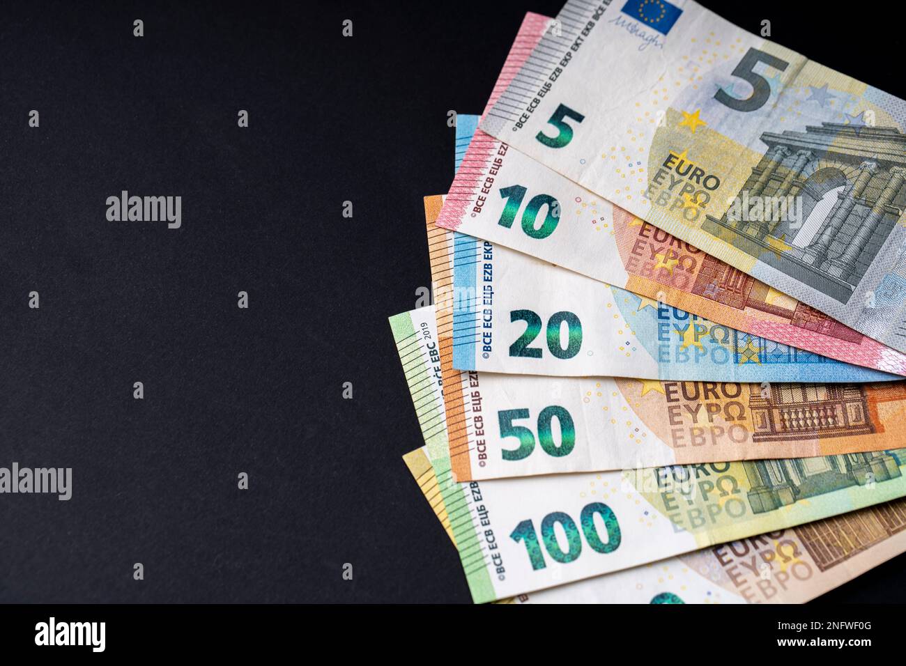 Different euro banknotes in a row close up, black background for ...