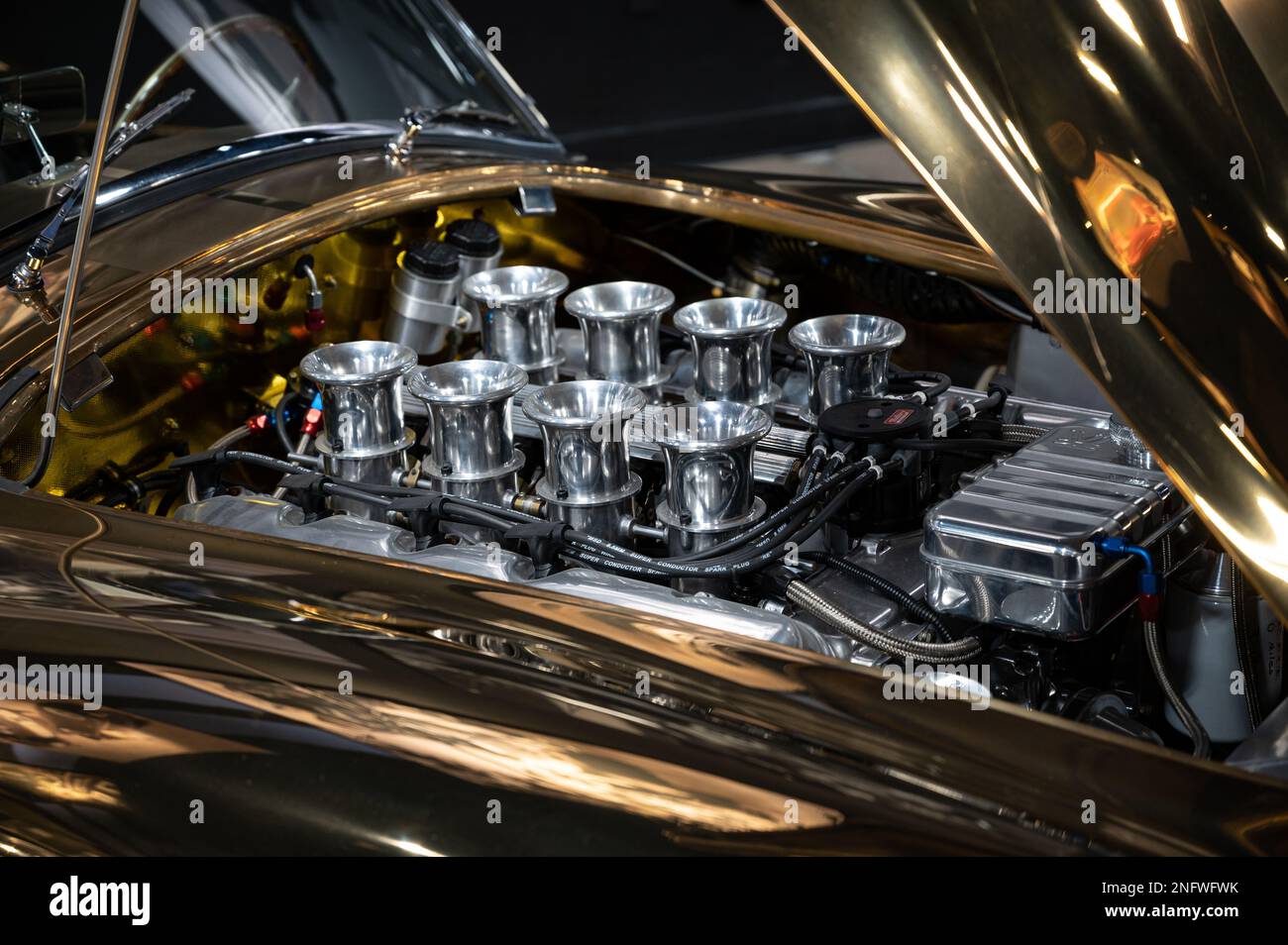 A detail of the engine of the exclusive AC Shelby Cobra 427 SC in gold ...